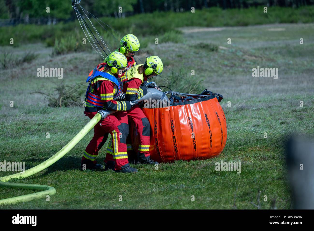 Erlangen, Germany. 01st May, 2025. Firefighters fill a firefighting bag ...