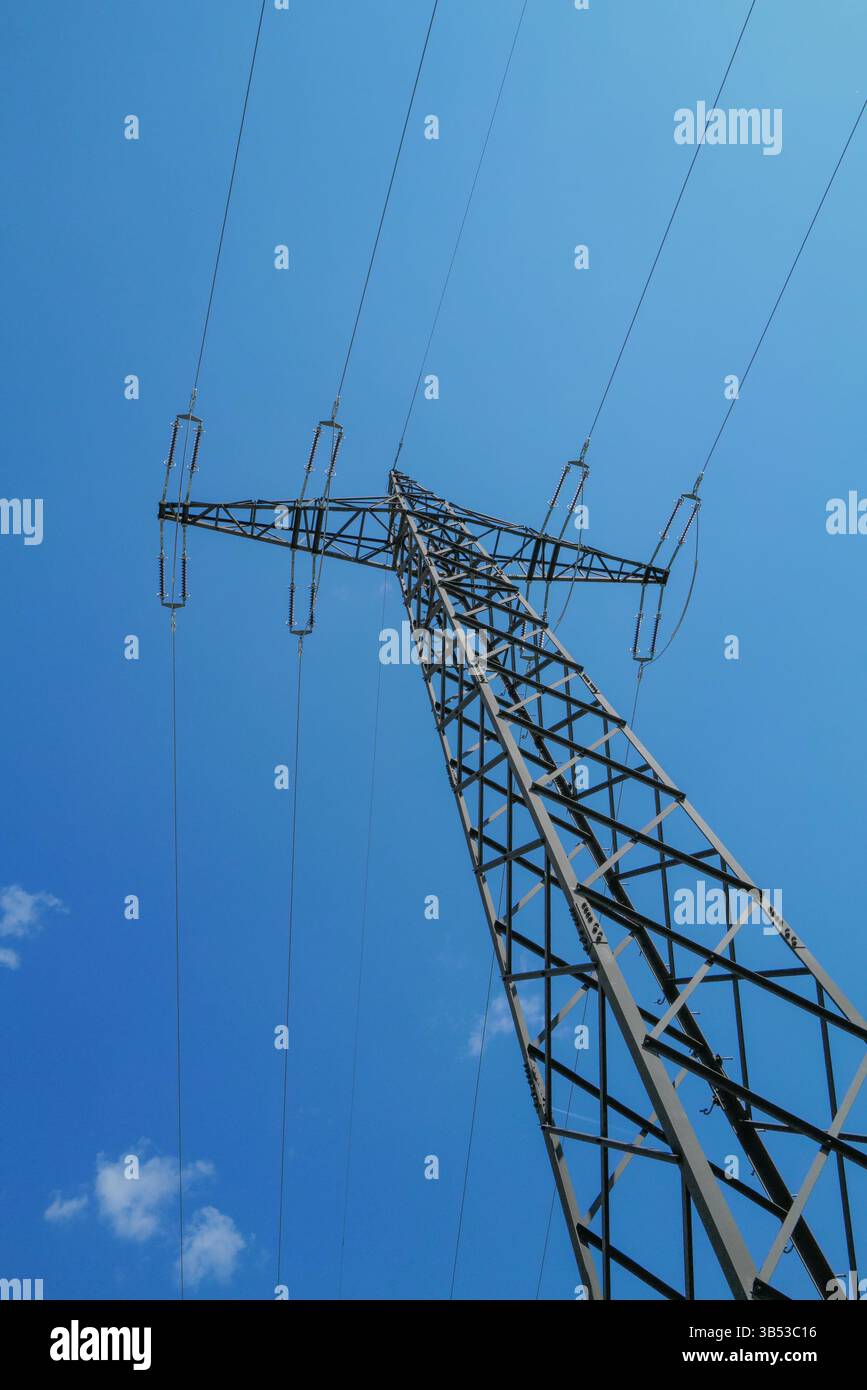 High-voltage power pylon in sunshine Stock Photo - Alamy