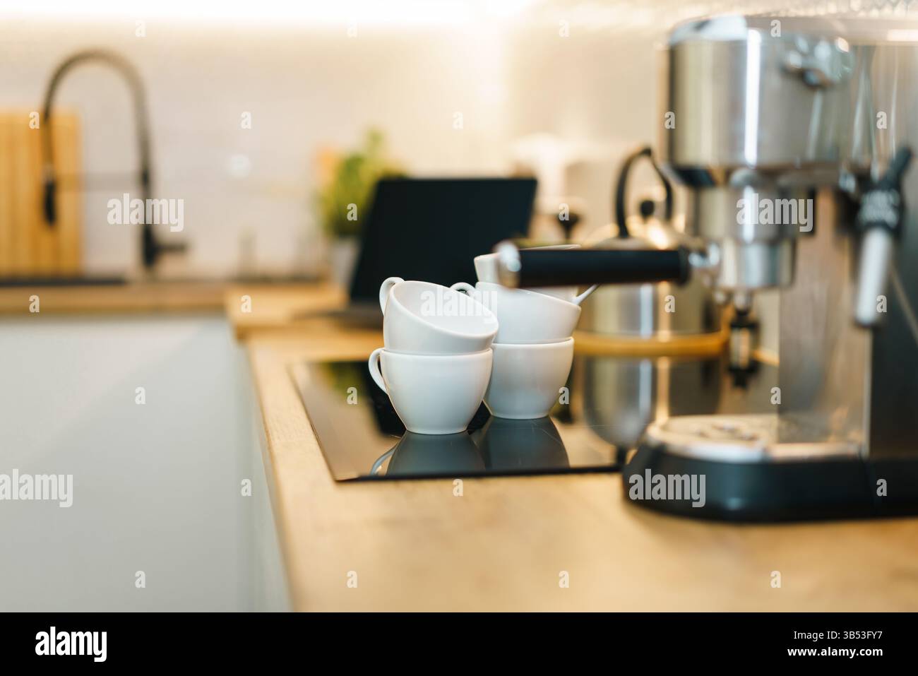 Close-up stylish espresso machine stacked white cups on modern kitchen ...