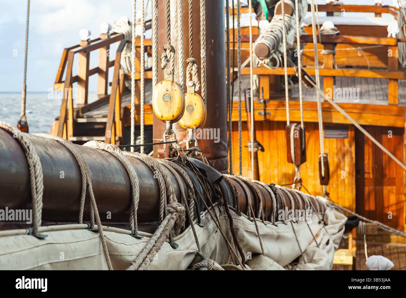 Traditional wooden sailing ship. Part of an old wooden ship with ropes ...