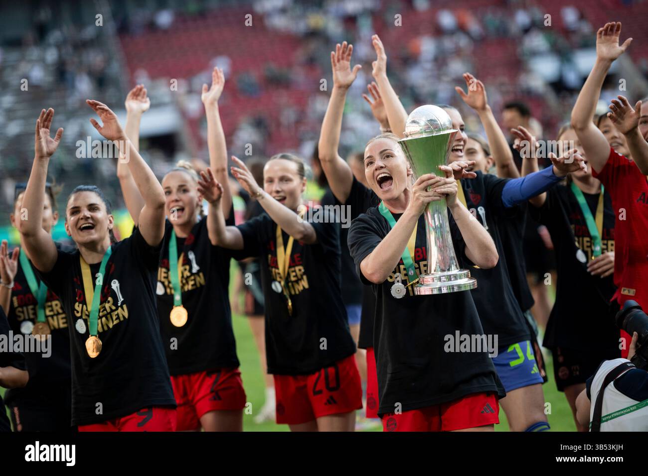 Bayern Munich's players celebrate with the trophy after winning the ...