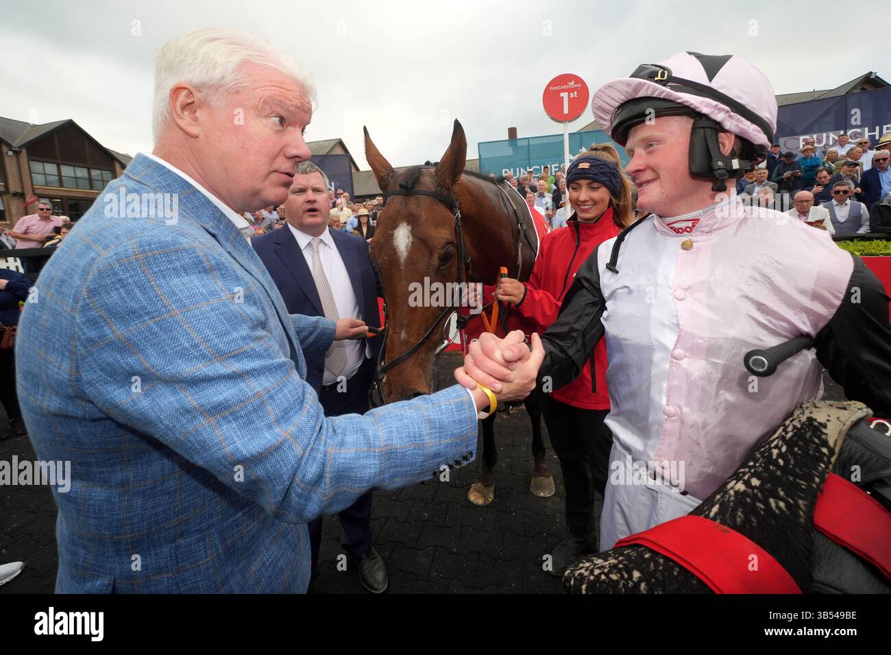 Owner Brian Acheson (left) congratulates jockey Sam Ewing after victory ...