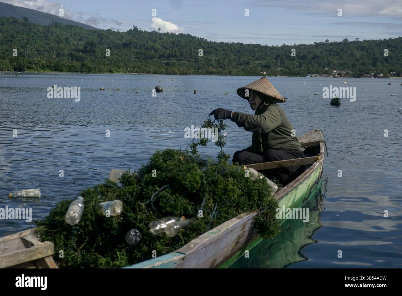 April 7, 2022, Poso, Central Sulawesi, Indonesia: A fisherman lifts ...