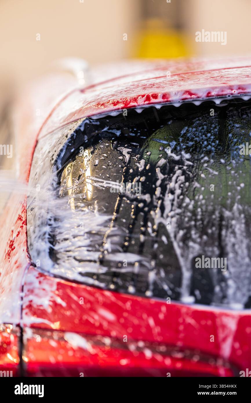 Red car being washed at a wash station Stock Photo - Alamy