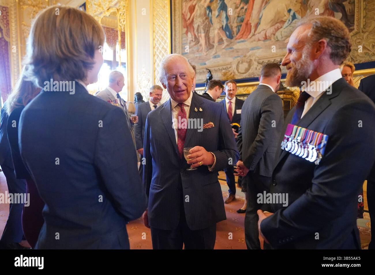 King Charles III talking to guests during a reception for the Victoria ...