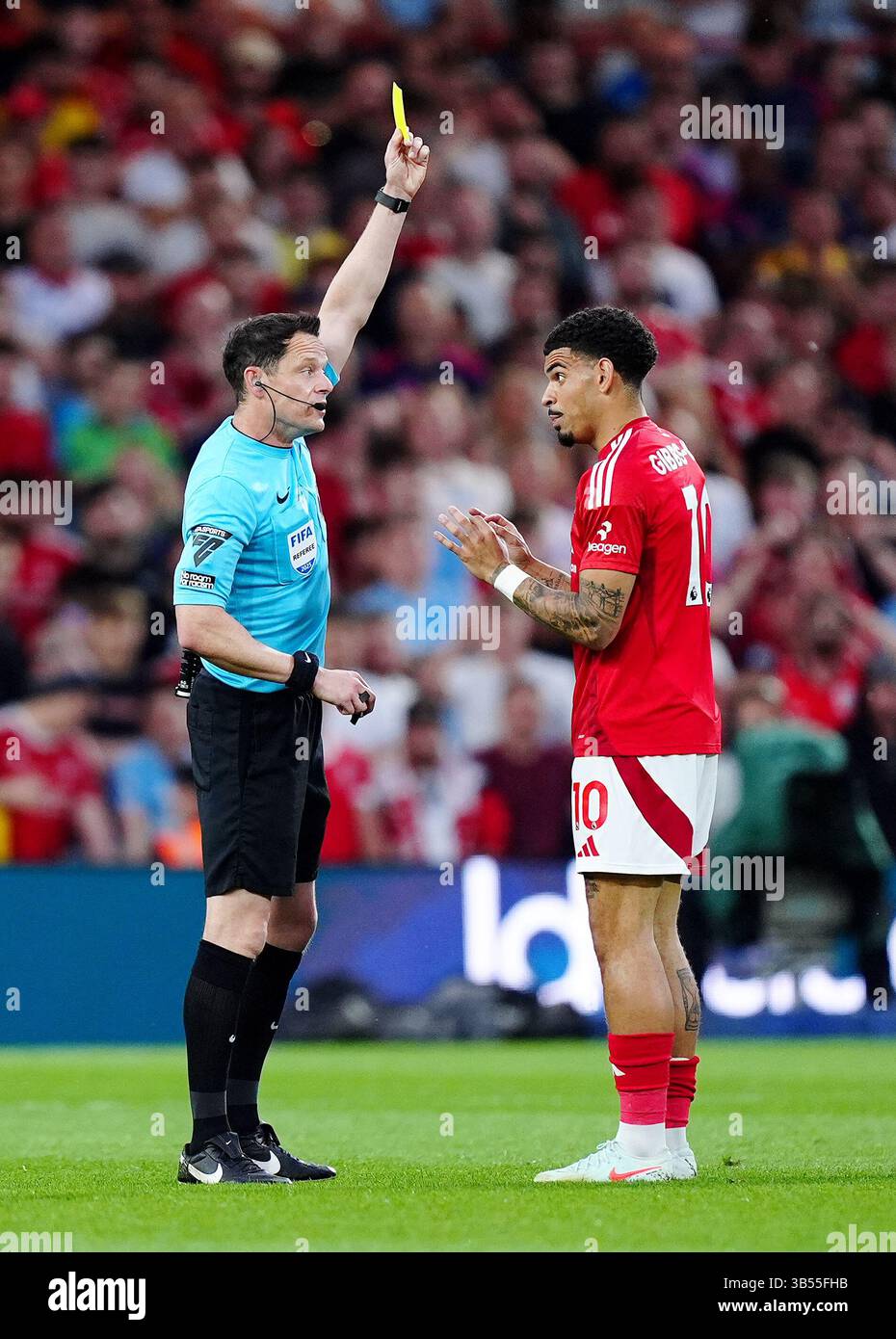 Nottingham Forest's Morgan Gibbs-White (right) is shown a yellow card ...