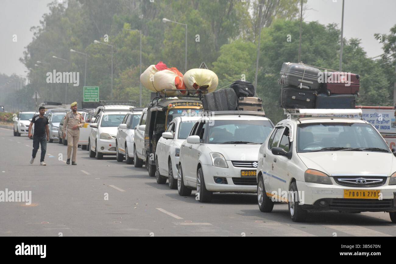 AMRITSAR, INDIA - MAY 1: Long queue of vehicles with luggage and ...