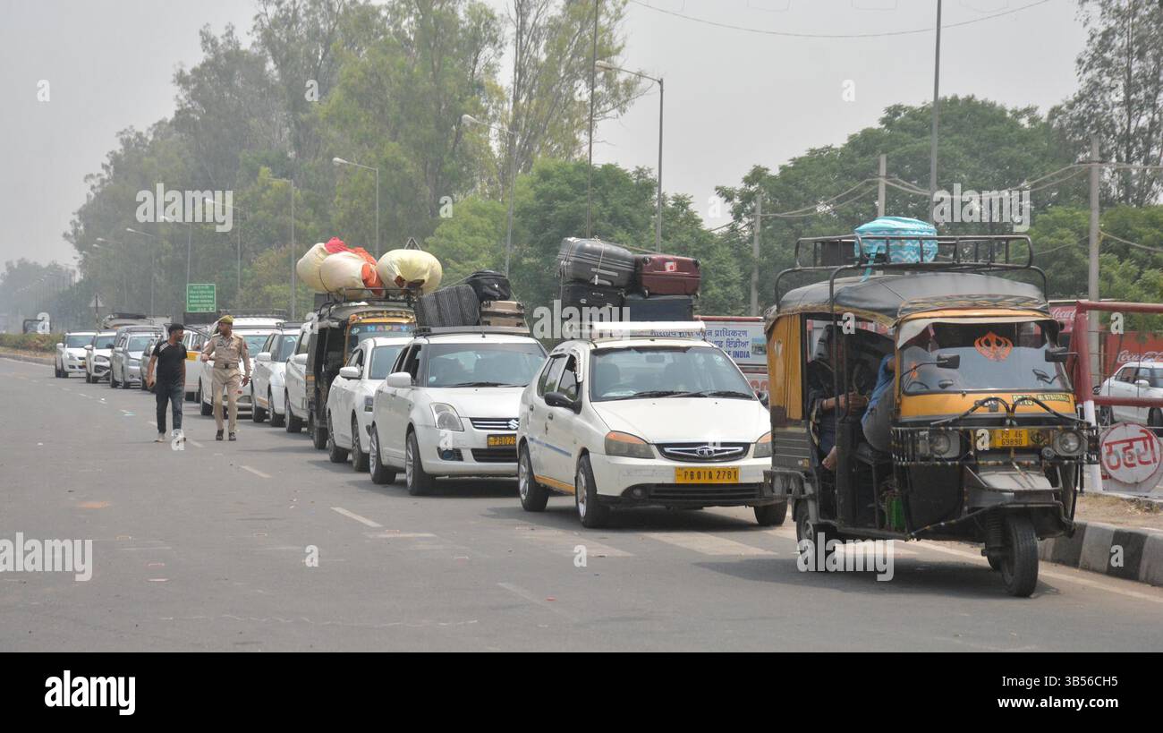 AMRITSAR, INDIA - MAY 1: Long queue of vehicles with luggage and ...