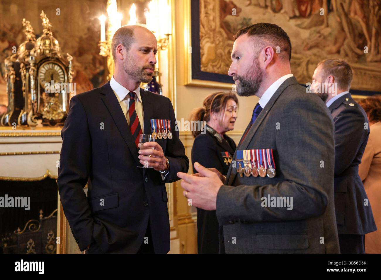 Britain's Prince William, left, talks with George Cross recipient ...