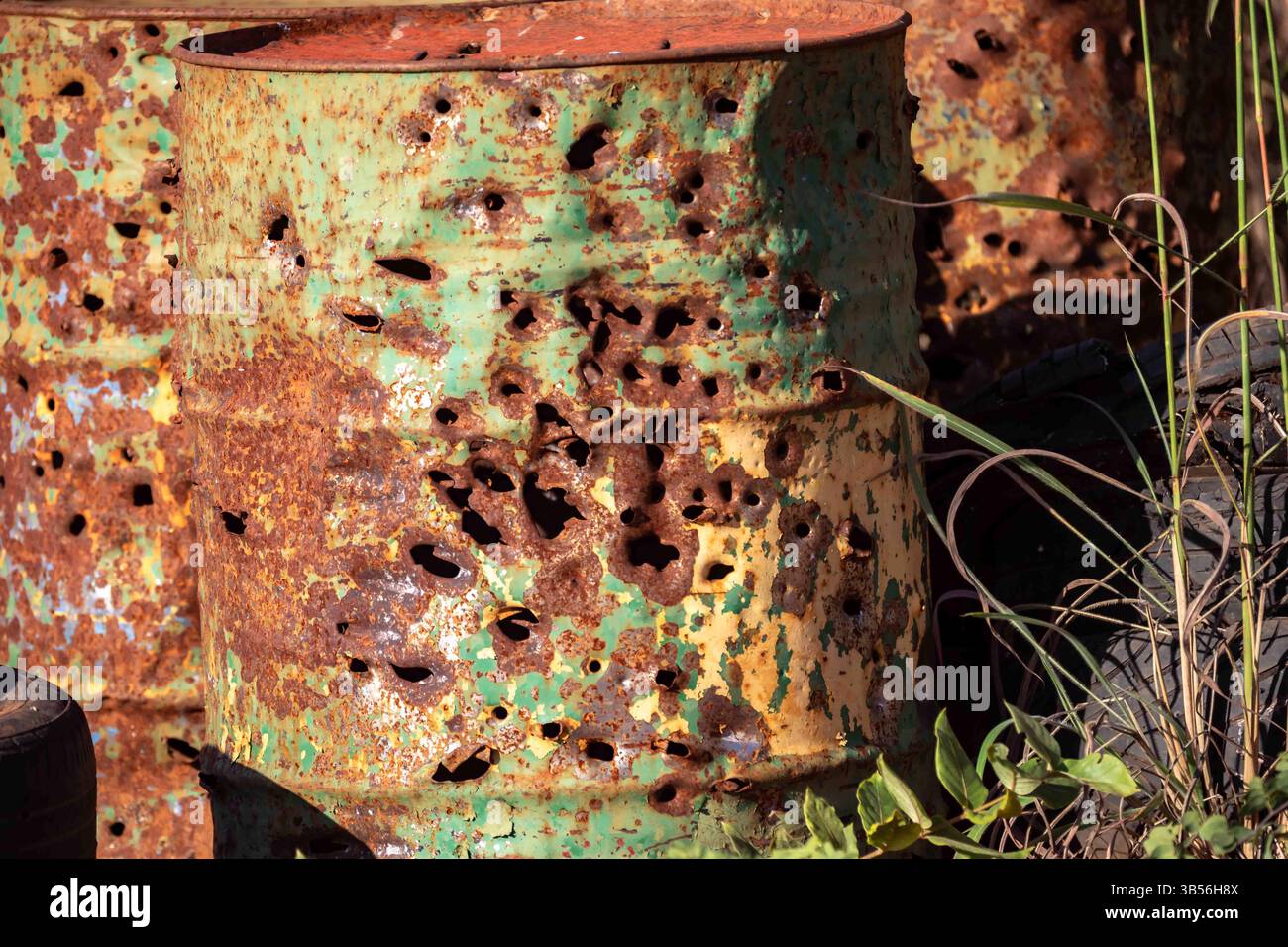Rustic background with brass drums pierced by gunshots Stock Photo - Alamy