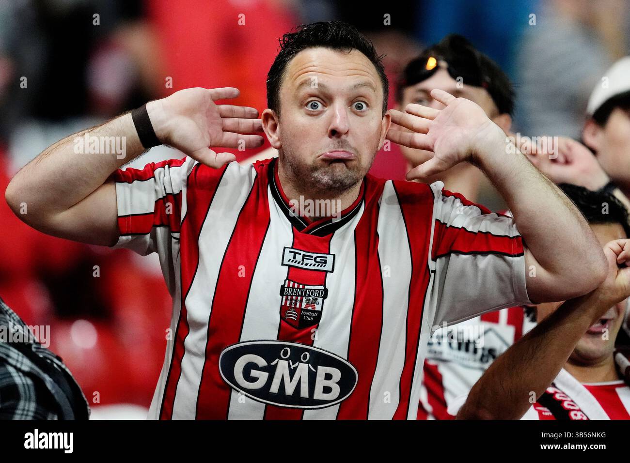 A Brentford fan gestures towards the Nottingham Forest fans during the ...
