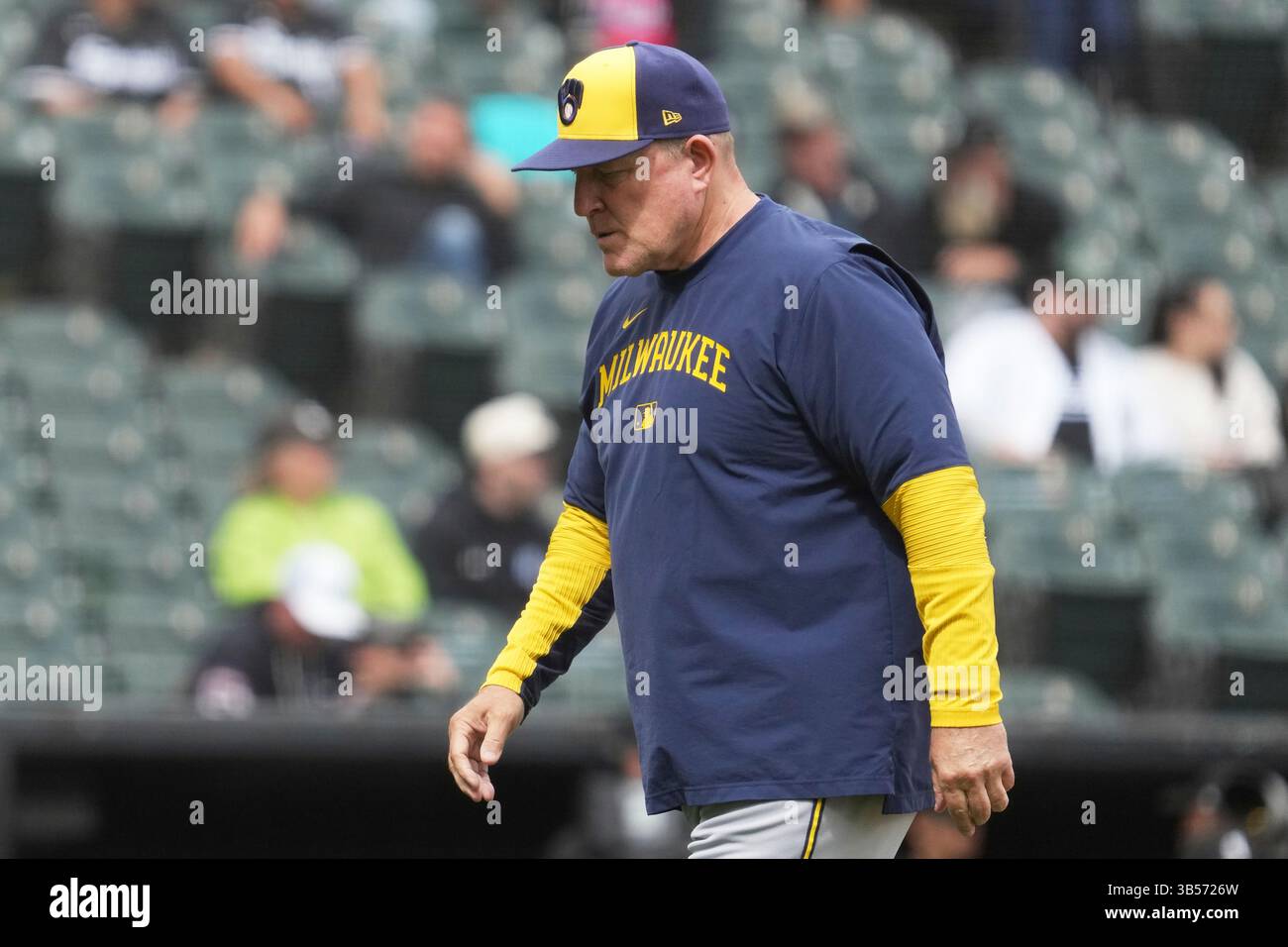 Milwaukee Brewers manager Pat Murphy looks down as he walks back to the dugout after inserting ...