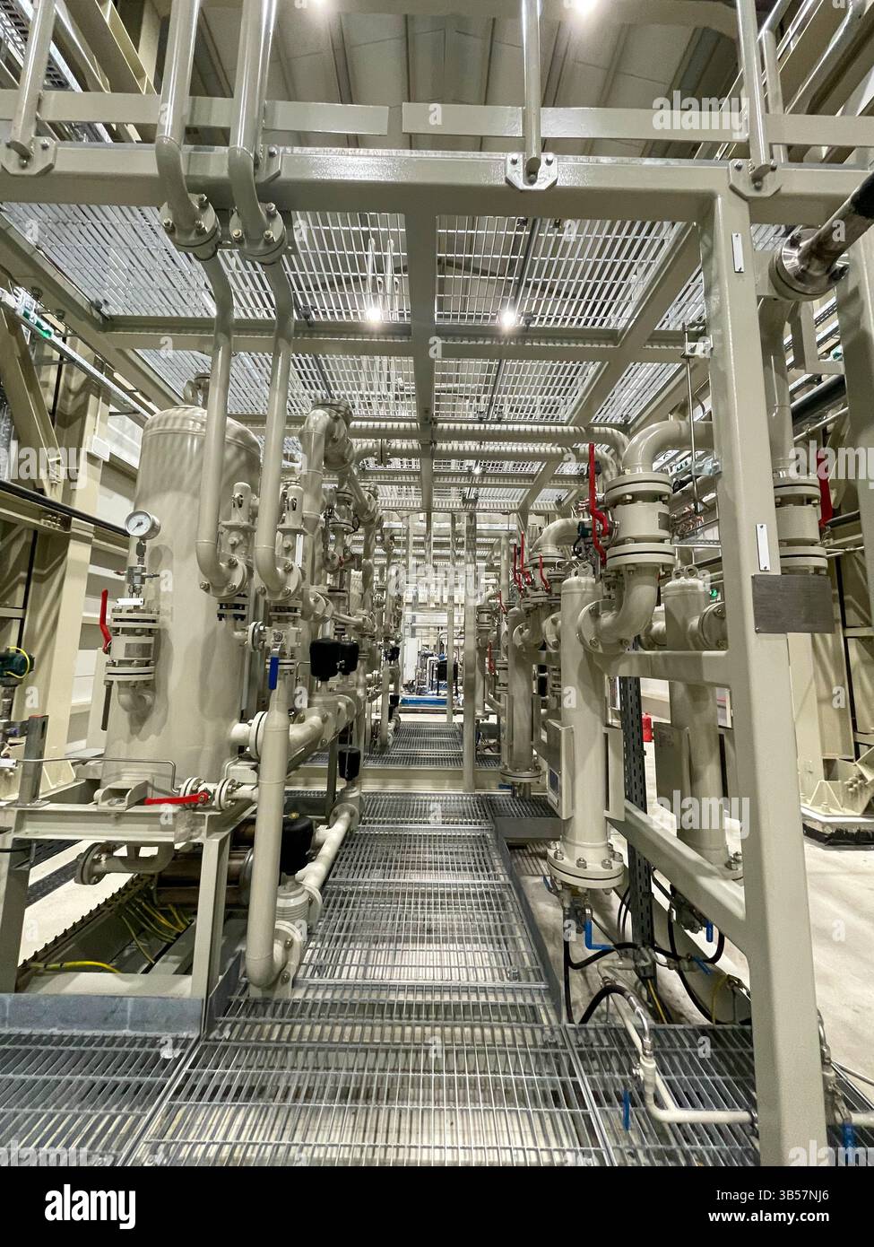 Industrial facility showcasing a complex system of pipes, valves, tanks ...