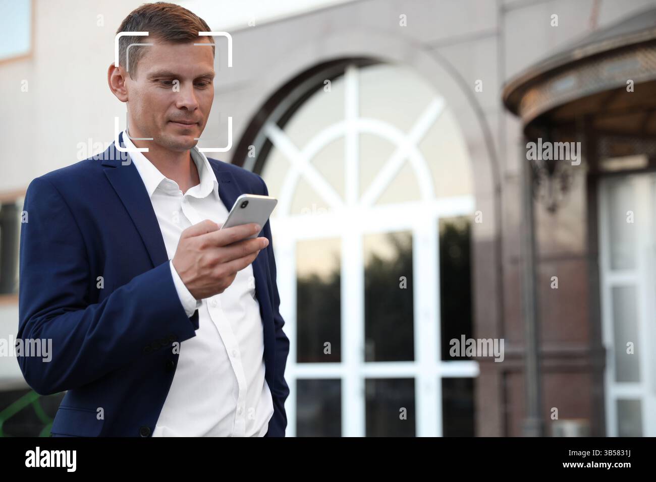 Facial recognition system identifying man using smartphone on city ...