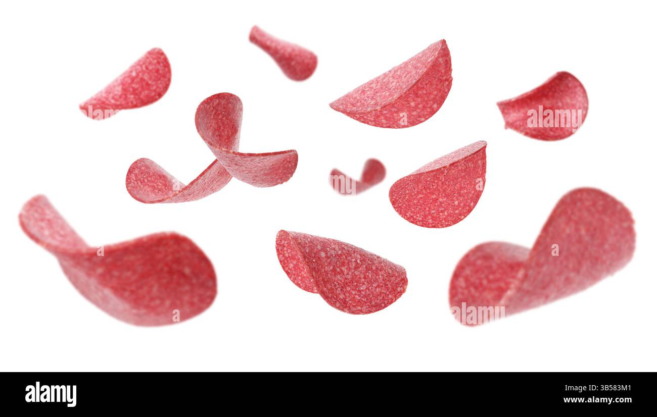 Salami sausage slices flying on white background Stock Photo - Alamy