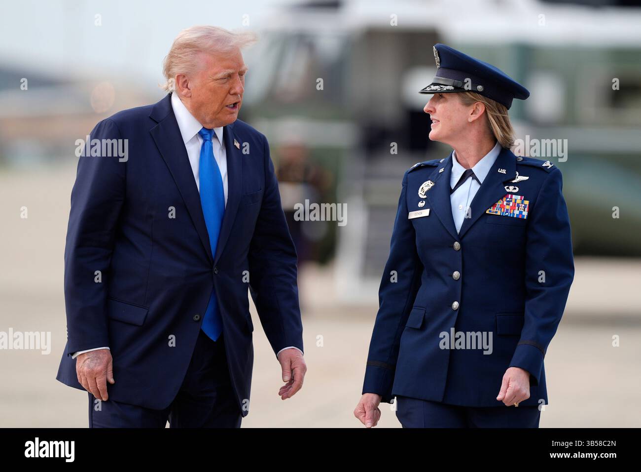 President Donald Trump walks with Air Force Col. Angela Ochoa ...