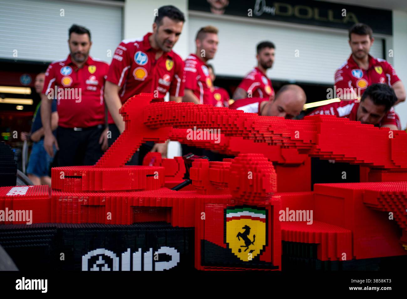 Scuderia Ferrari mechanics look at a full-sized Lego car during the ...