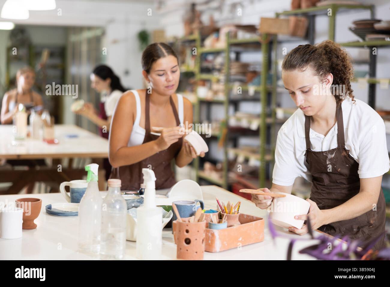 Guy performs polishing of ceramic product Stock Photo - Alamy