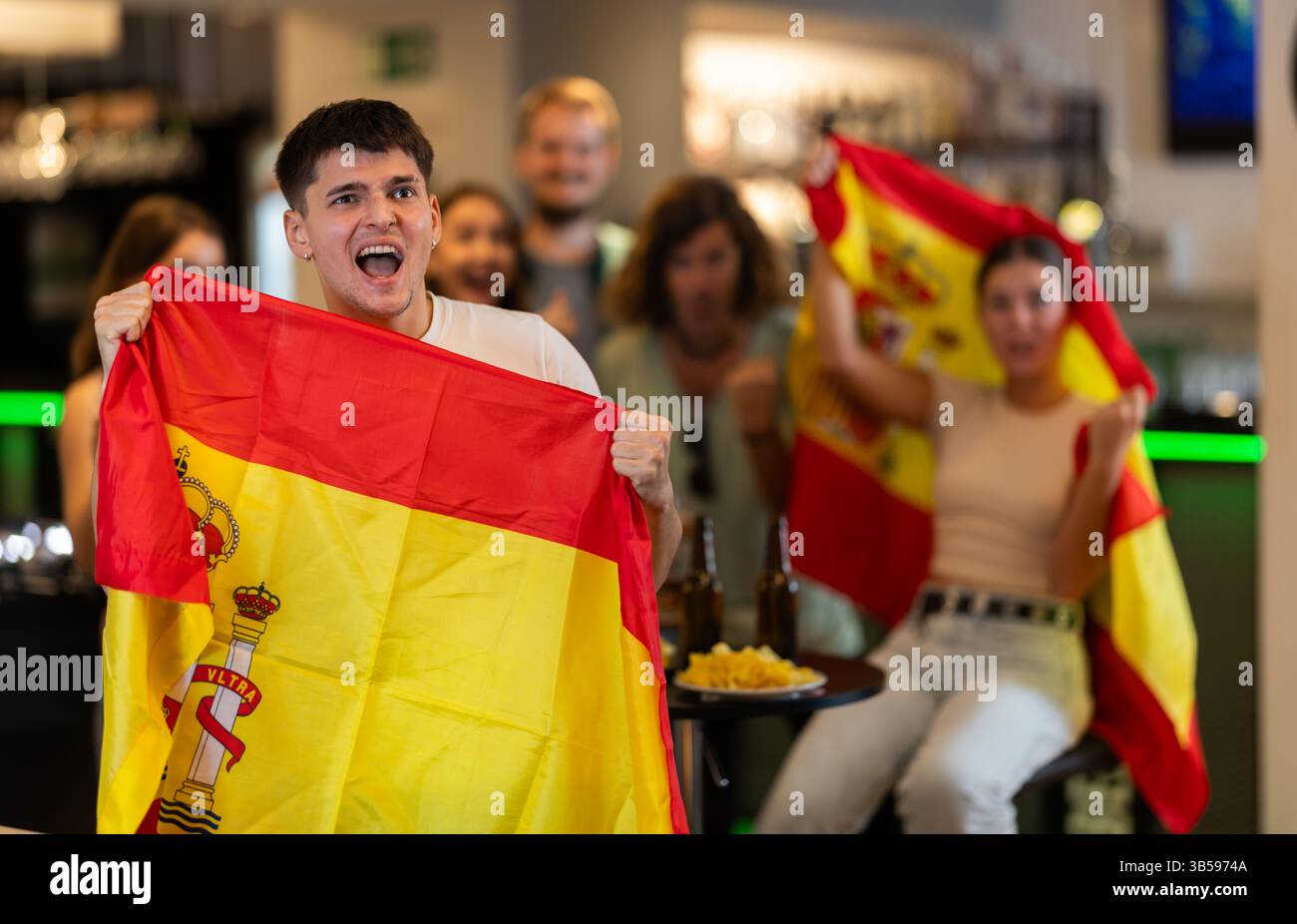 Group of fans in bar with Spanish flag Stock Photo - Alamy