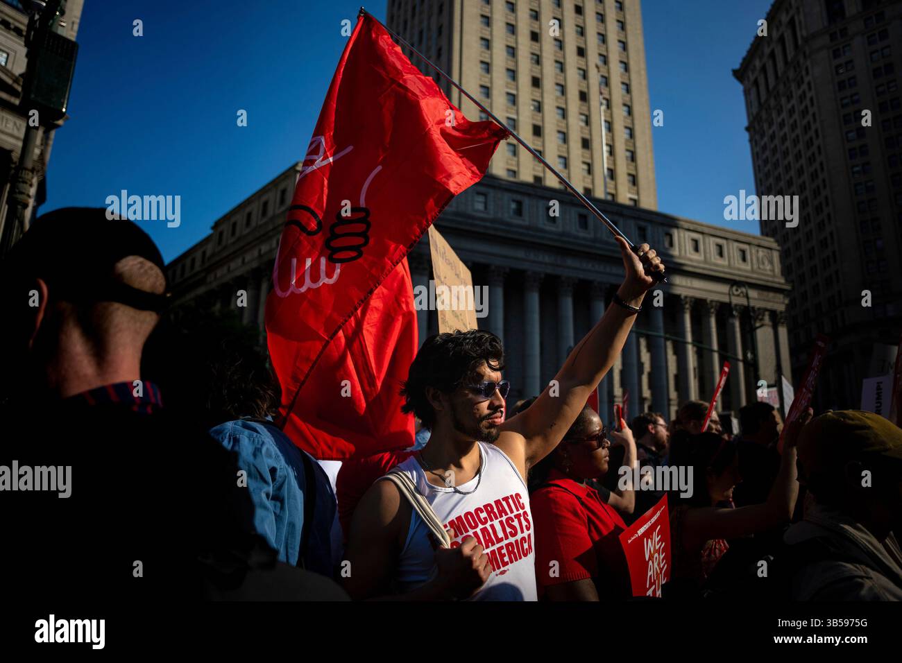 Alex Rivera holds up a pro-socialism flag during the NYCLU's May Day ...