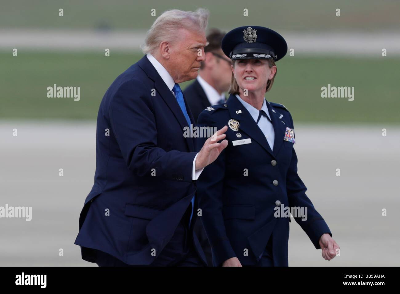 President Donald Trump, escorted by Air Force Col. Angela F. Ochoa ...