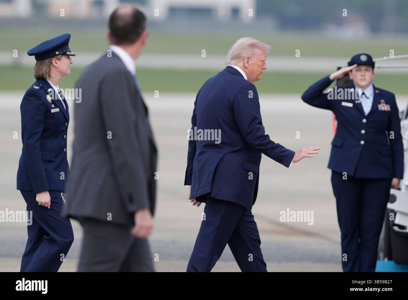 President Donald Trump, center, escorted by Air Force Col. Angela F ...