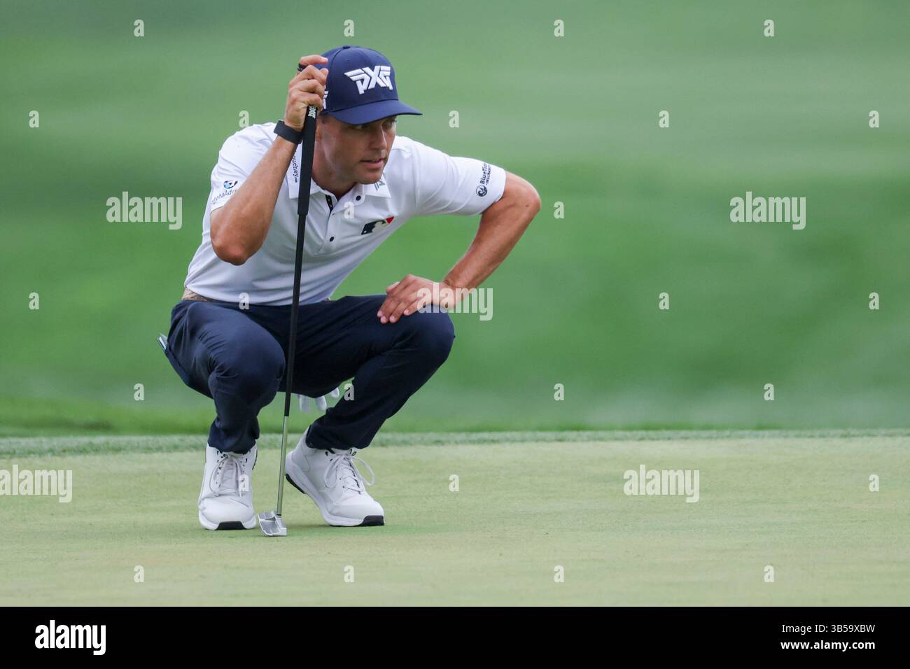 Eric Cole lines up a putt on the 16th green during the first round of ...
