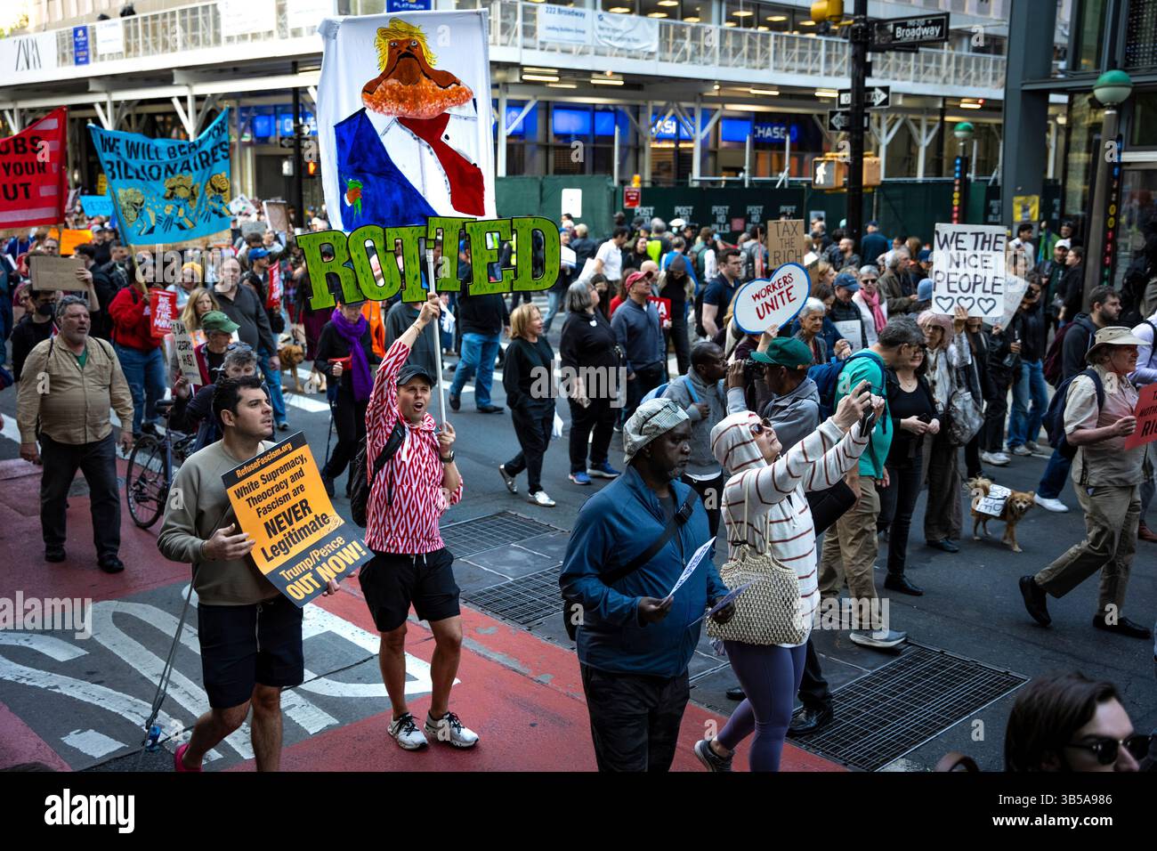 People hold signs and chant during the NYCLU's May Day rally for worker ...