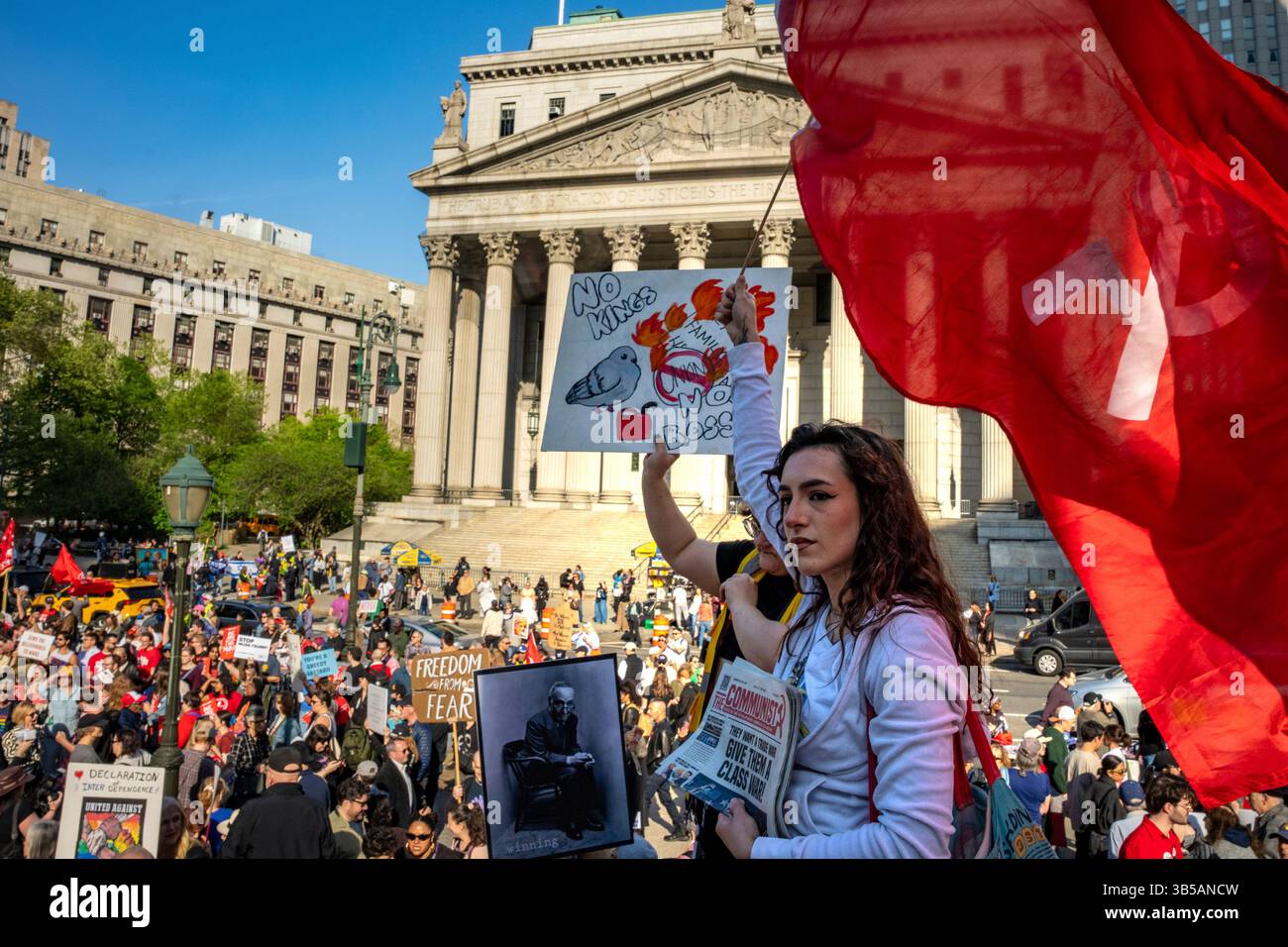 A woman holds a communism flag as people gather for the NYCLU's May Day ...