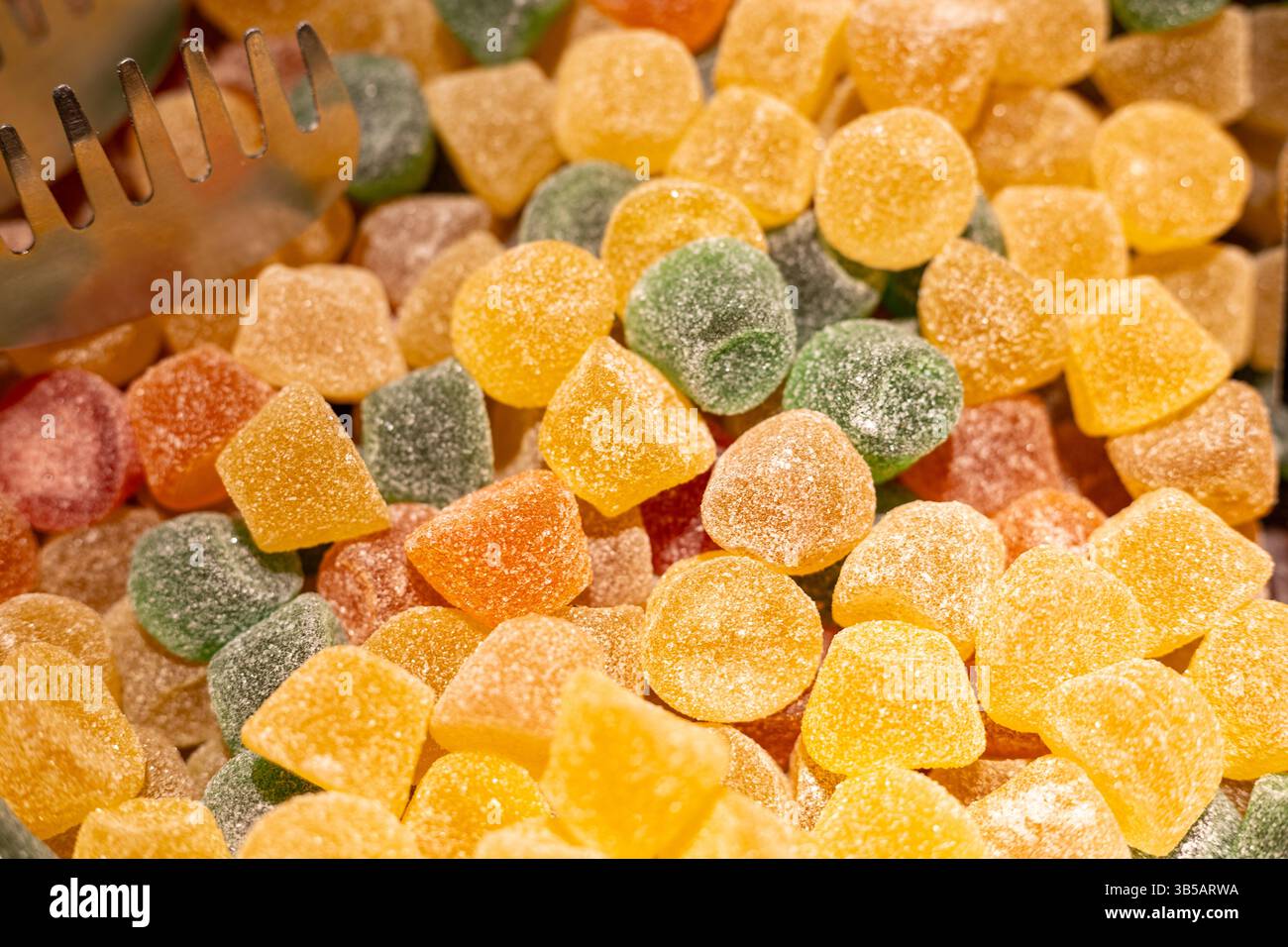 A vibrant assortment of gummy candies in various shapes and colors is ...