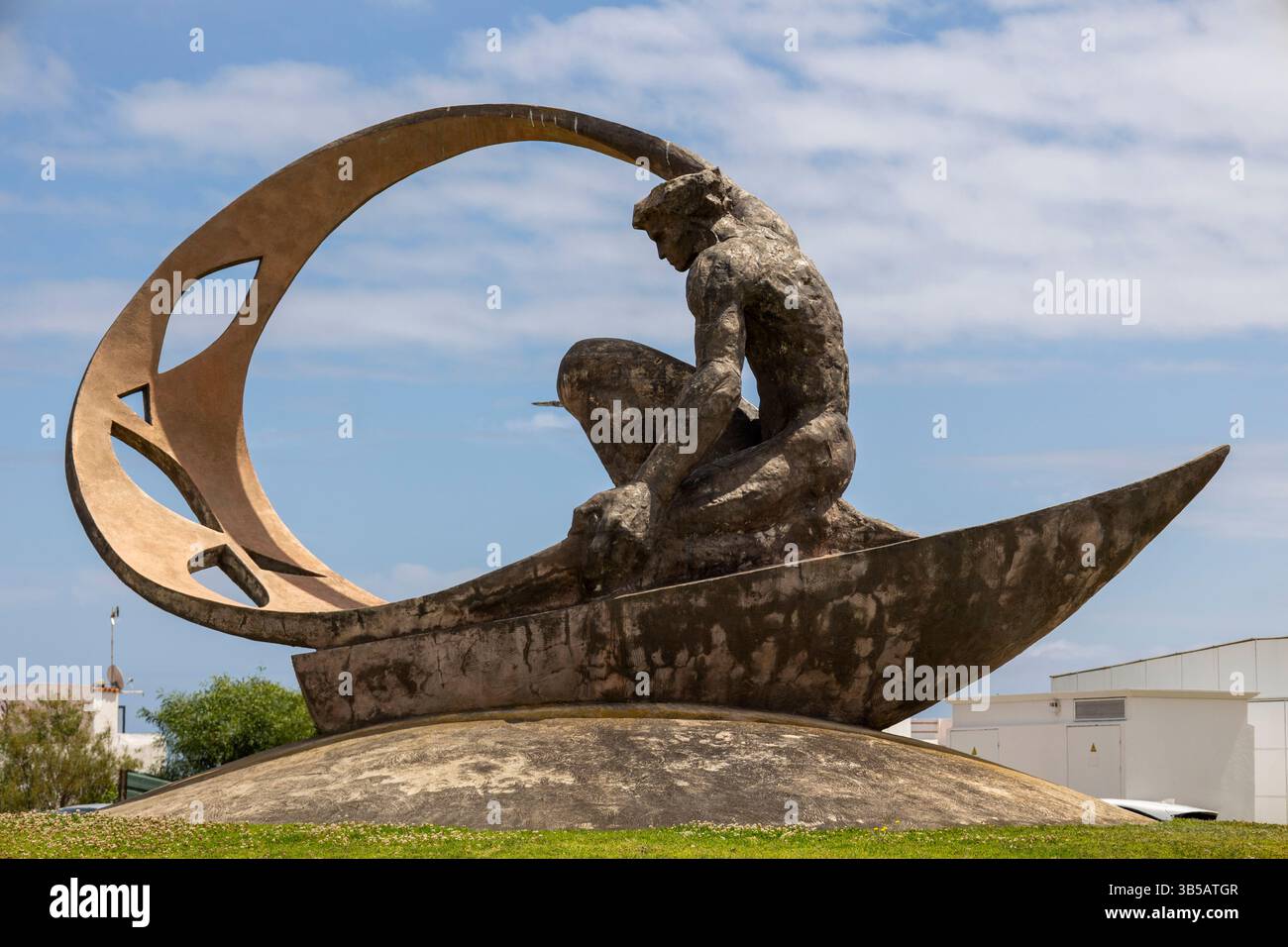 Statue of a fisherman throwing the net artwork in a roundabout in ...