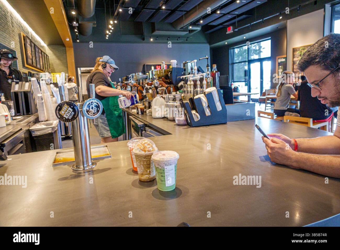 Green apron headset uniform hi-res stock photography and images - Alamy