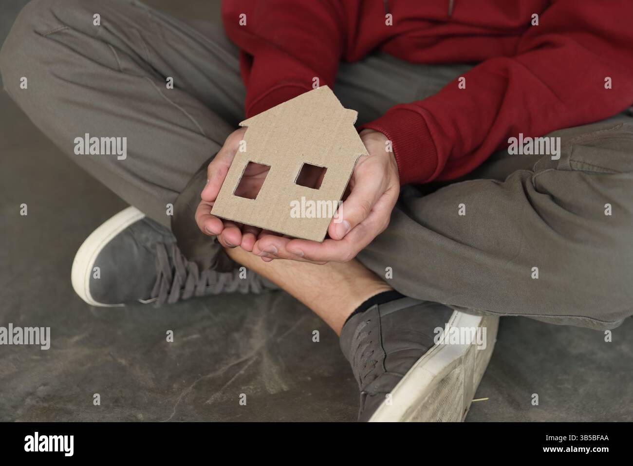 Homeless man with carton house figure outdoors, closeup Stock Photo - Alamy