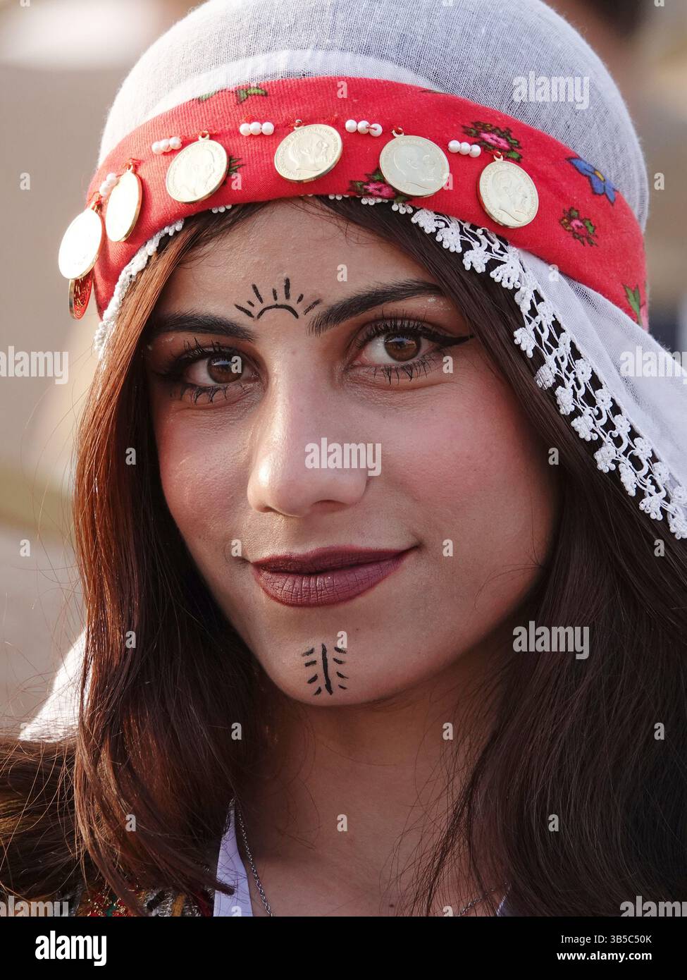 A young Kurdish woman is seen displaying women's clothing of Kurds ...