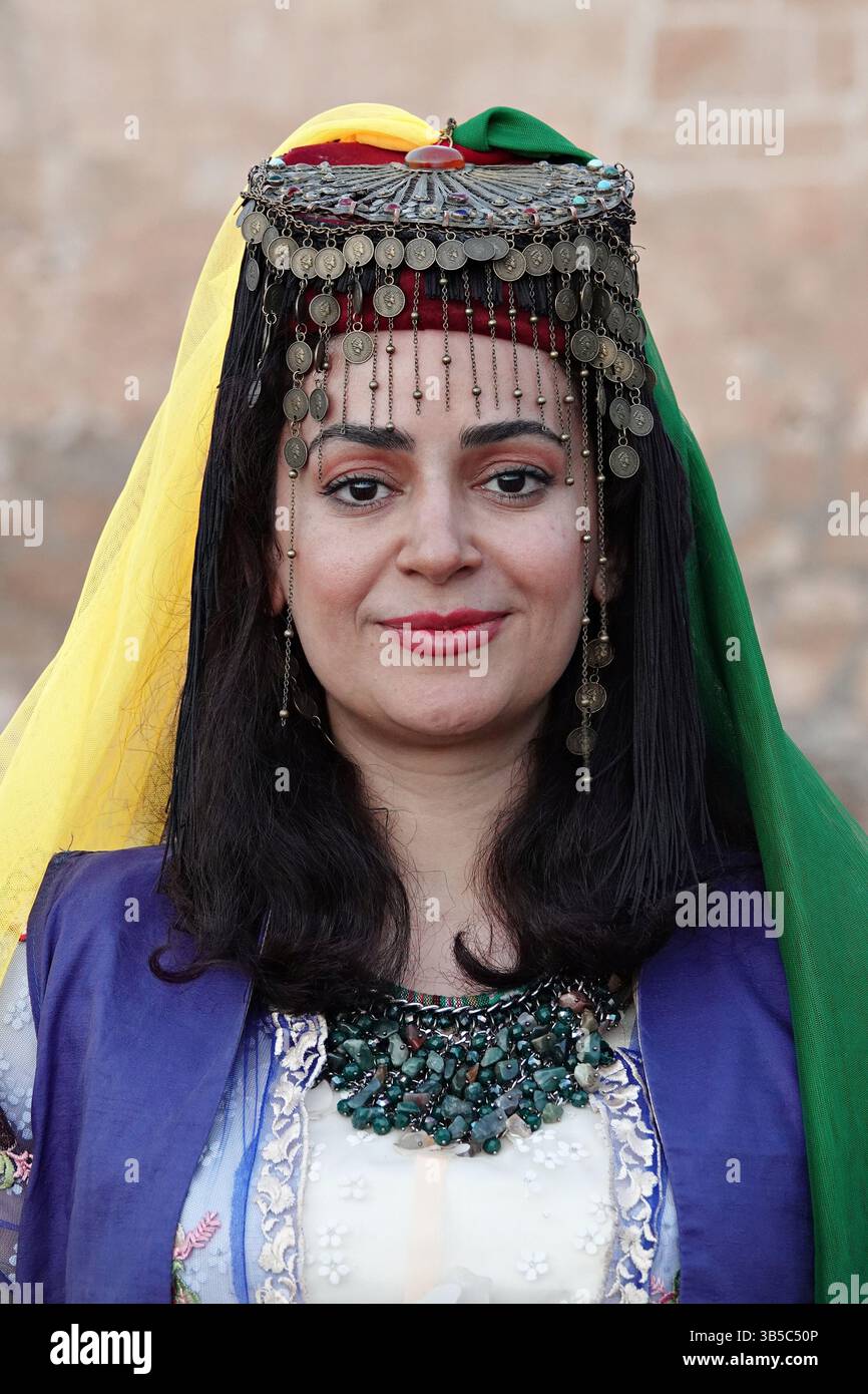Kurdish clothes researcher Sonbol Shojai is seen displaying the ...