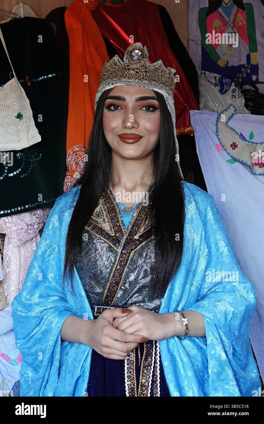 A young Kurdish woman is seen displaying women's clothing of Kurds ...