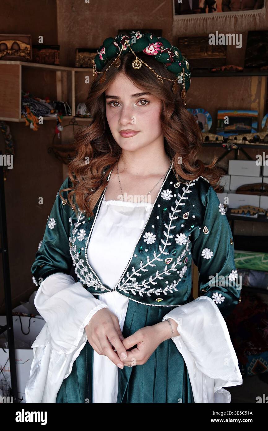 A young Kurdish woman is seen displaying women's clothing of Kurds ...