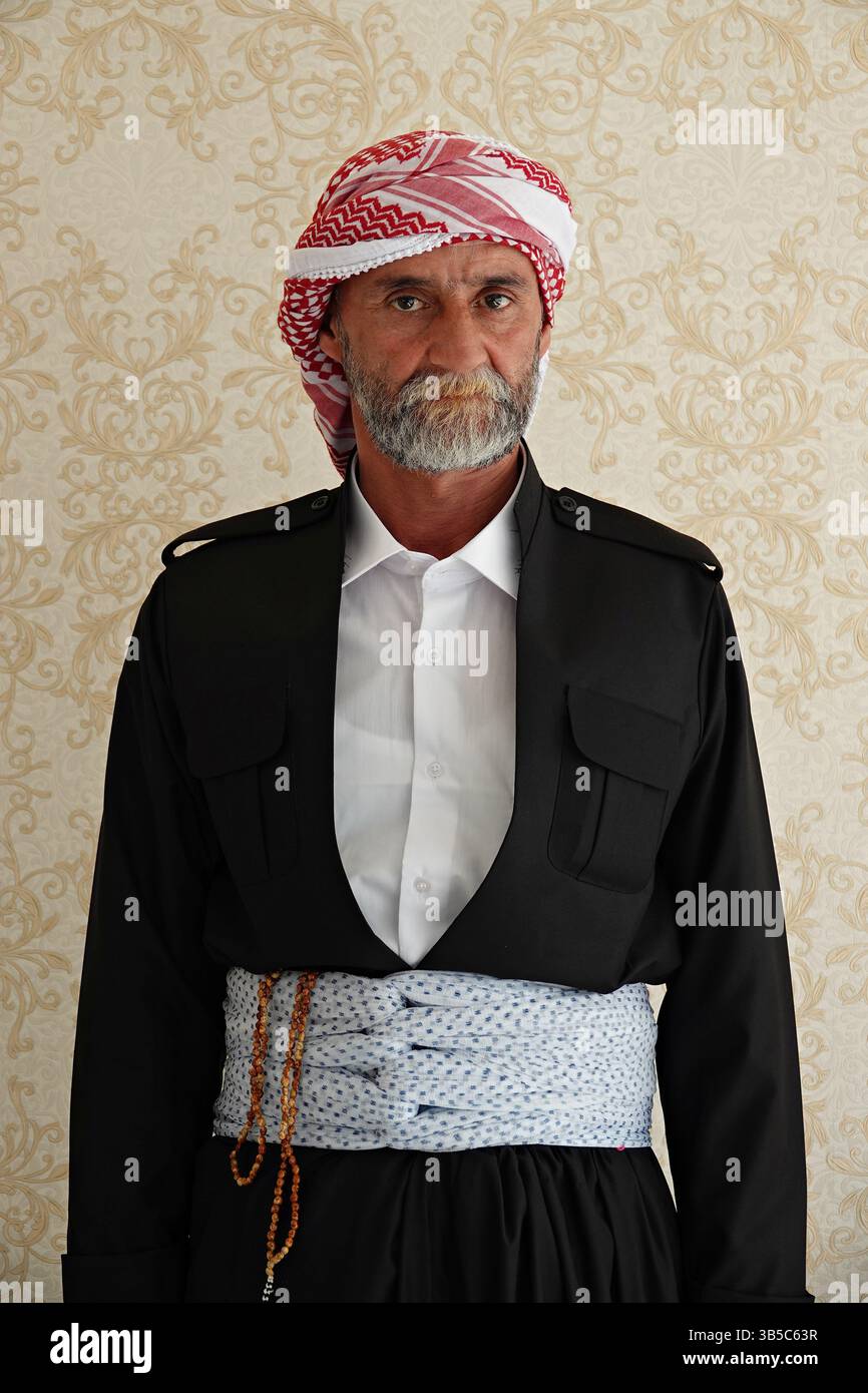 A Kurdish man is seen showing off the dress of the Barzan region in ...