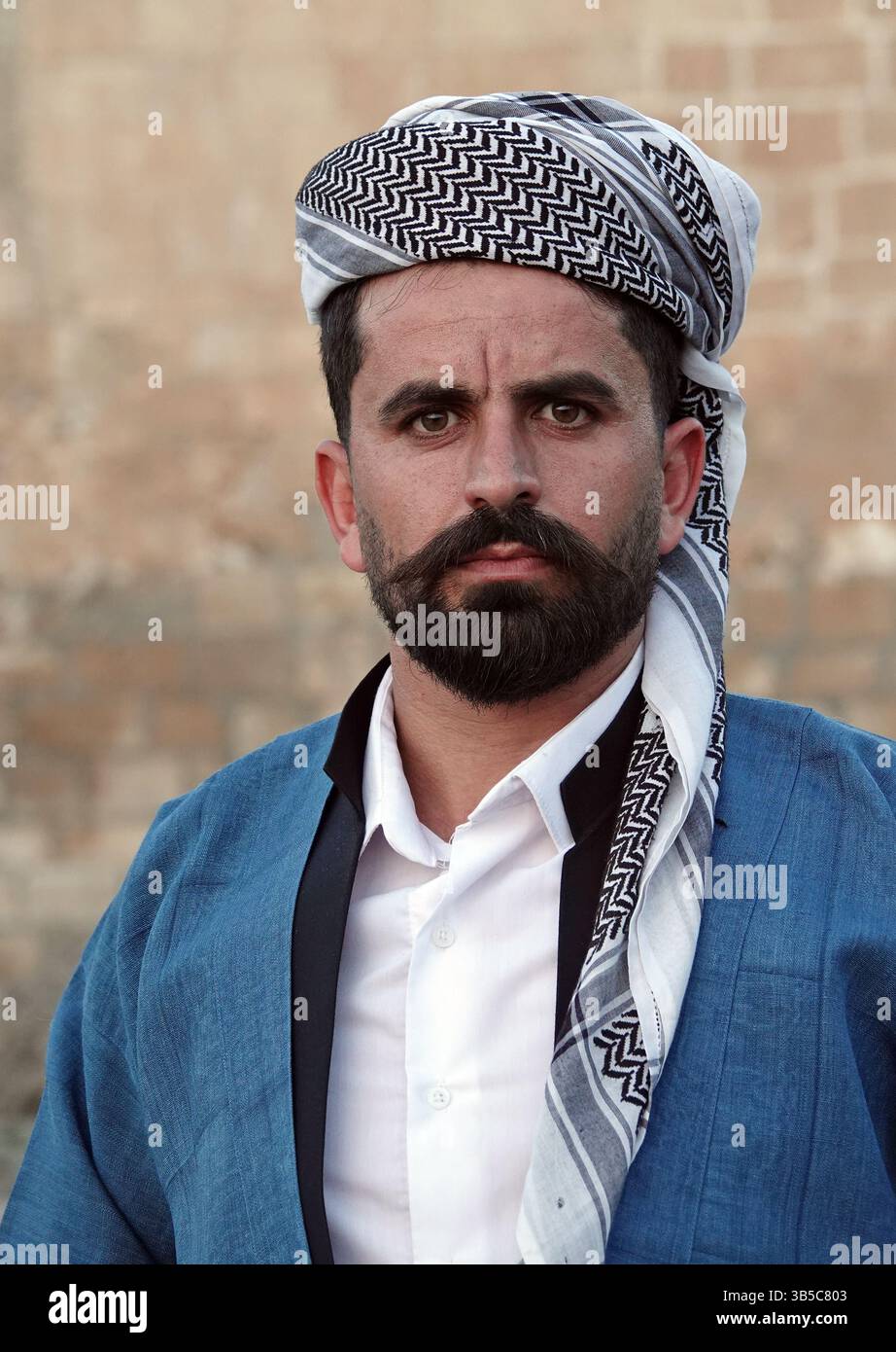 A Kurdish teenager is seen showing off the dress of the Barzan region ...