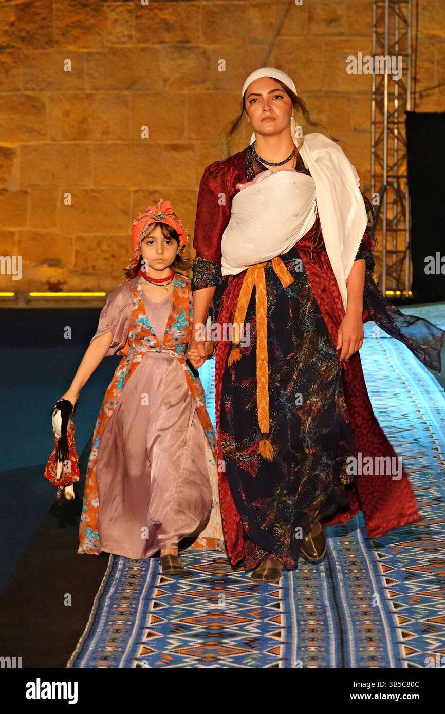 A Kurdish woman is seen displaying the women's dress of the Barzan ...