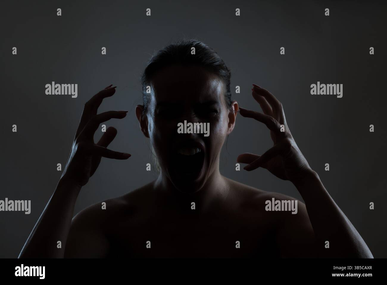 Image captures an intense moment of a woman expressing fierce emotions ...