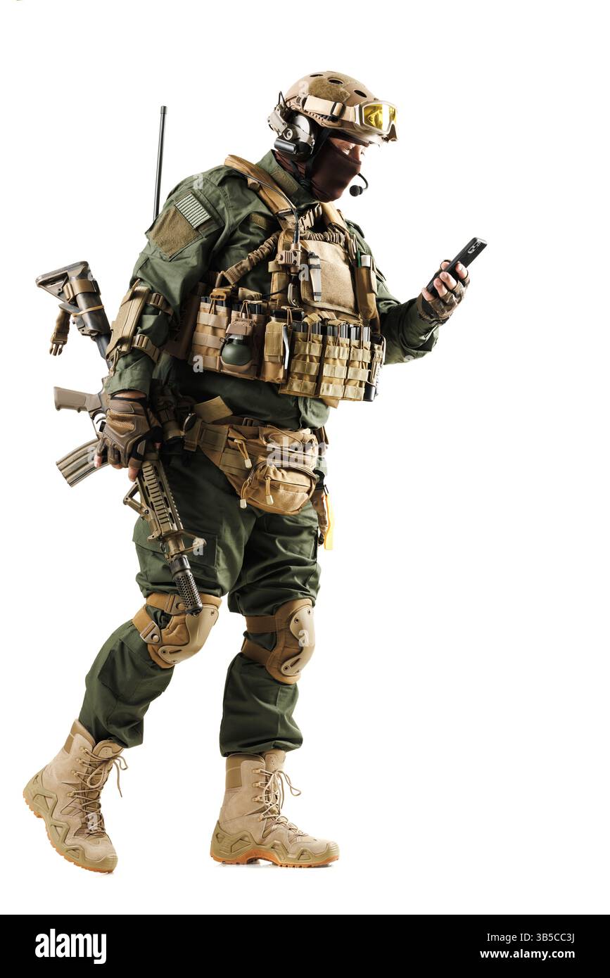 Soldier fully equipped with tactical gear, carrying a rifle, and ...