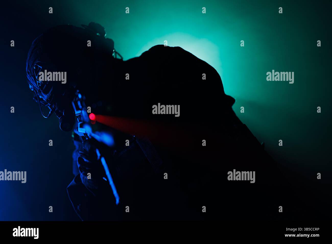 A silhouette of a soldier posed in a tactical stance, aiming a rifle ...