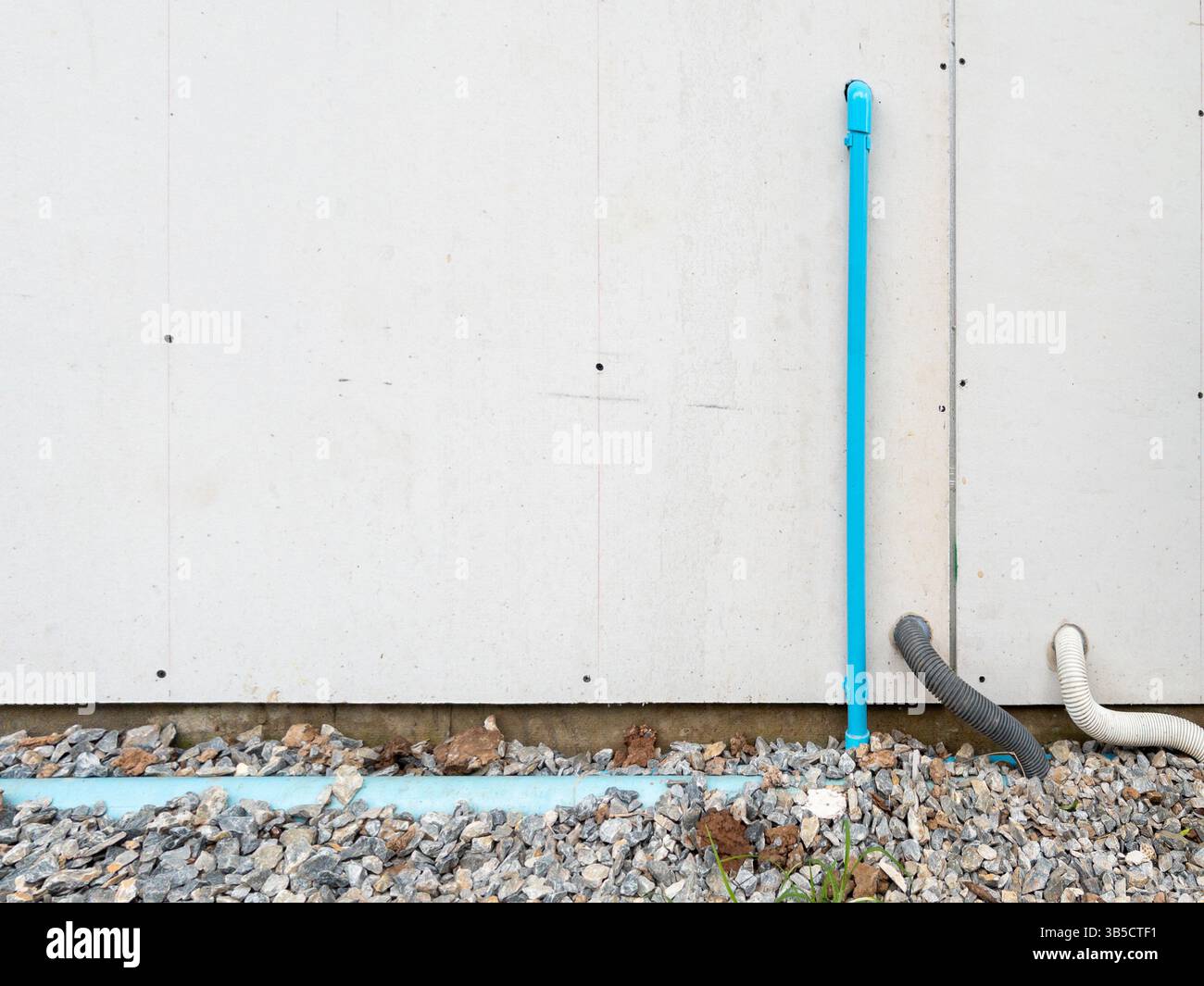 Essential PVC and drainage pipes on the backside wall of a restaurant ...