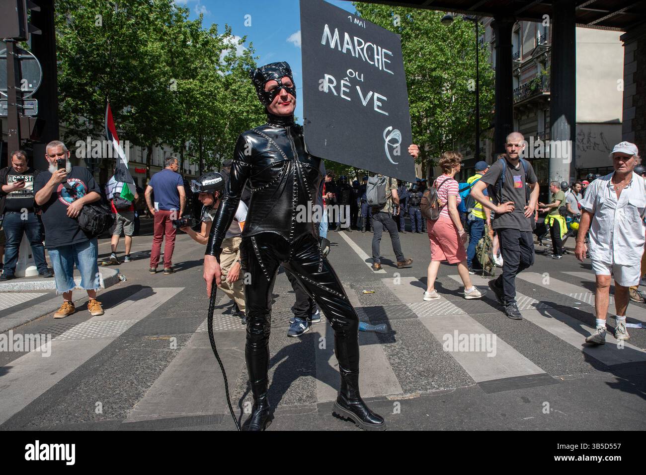 A protester dressed in cat leather dress and holds a placard during the ...