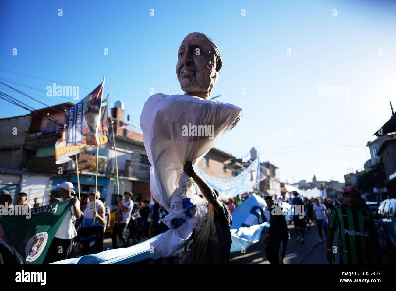 A mourner holds a giant puppet depicting the late Pope Francis during a ...