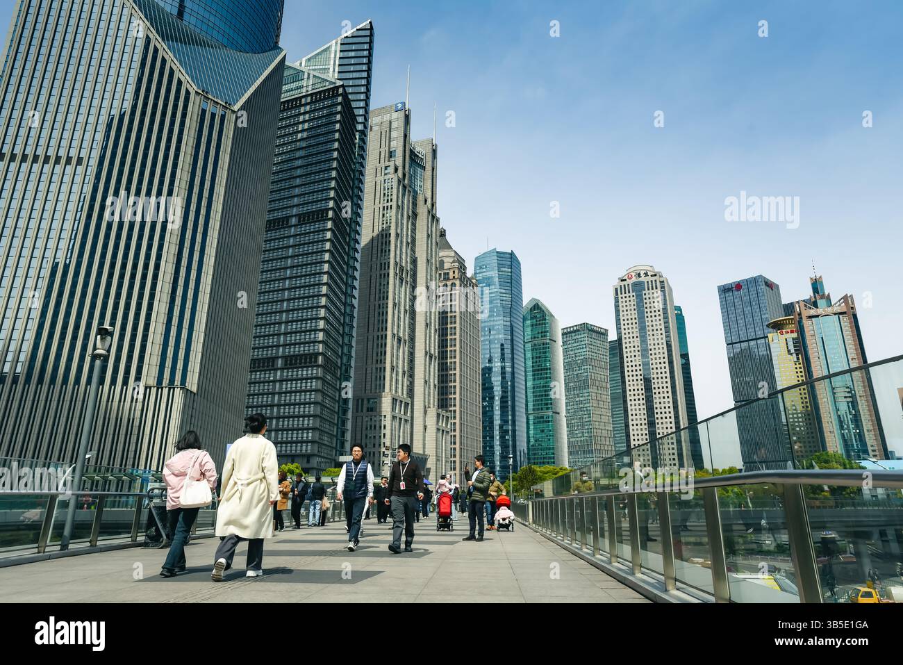 Shanghai, China – 1 April 2025: People walking on a pedestrian bridge ...