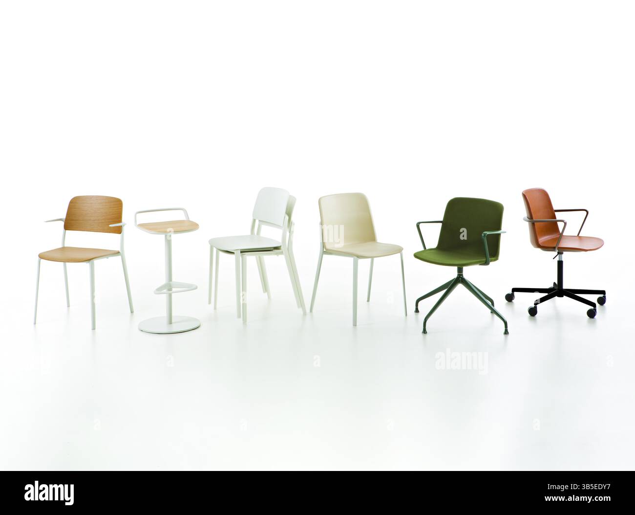 a row of various modern chairs and a stool are displayed on a white ...
