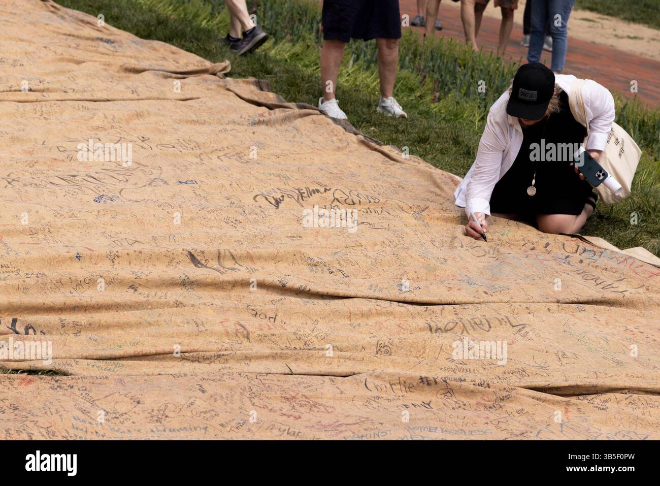 A protester signs a replica of the Declaration of Independence while ...