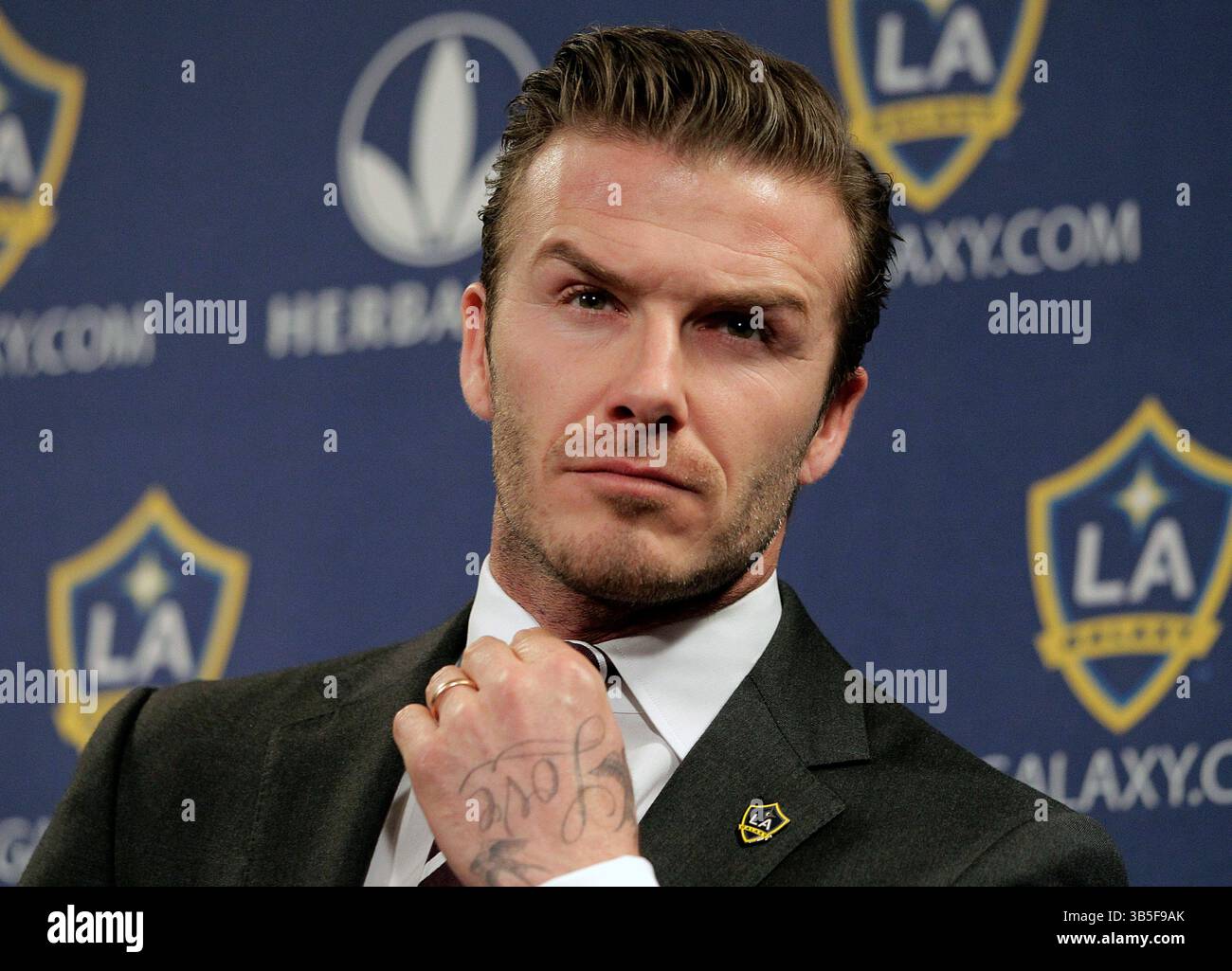 FILE - Los Angeles Galaxy's David Beckham fixes his tie during a news ...
